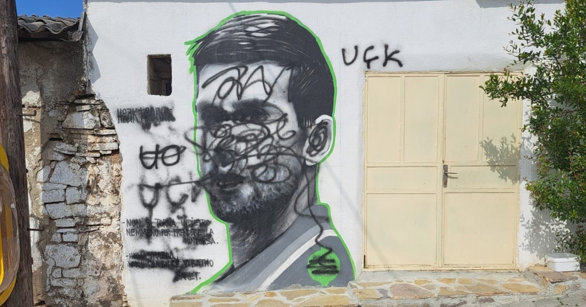 Graffiti "KLA" written over the mural with Novak Djokovic's image ...